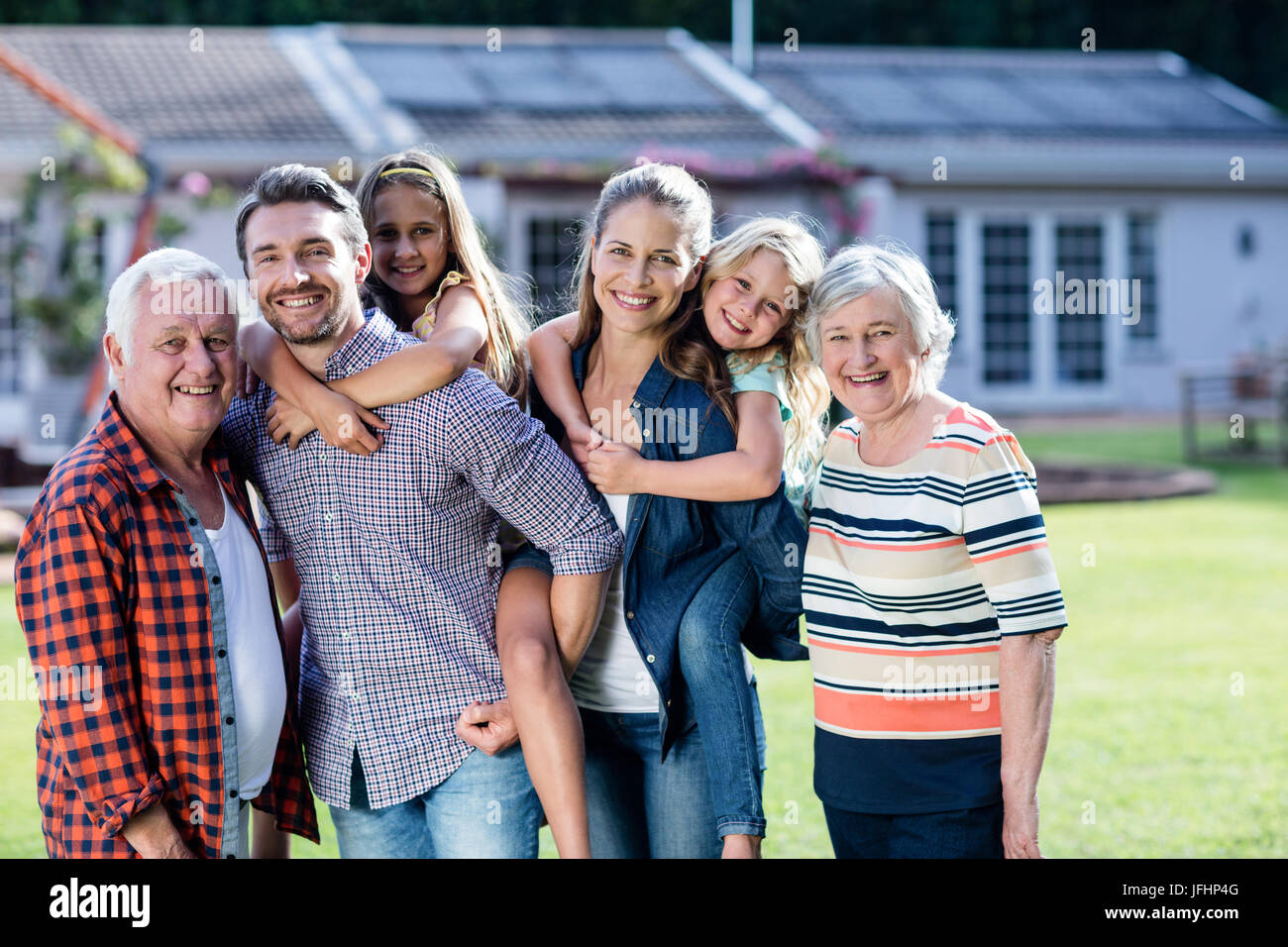 Portrait of multi-generation family standing in garden Stock Photo - Alamy