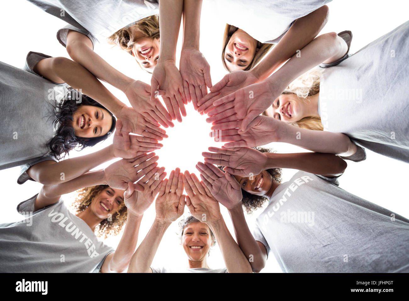Happy volunteers standing in a circle with their hands together Stock ...