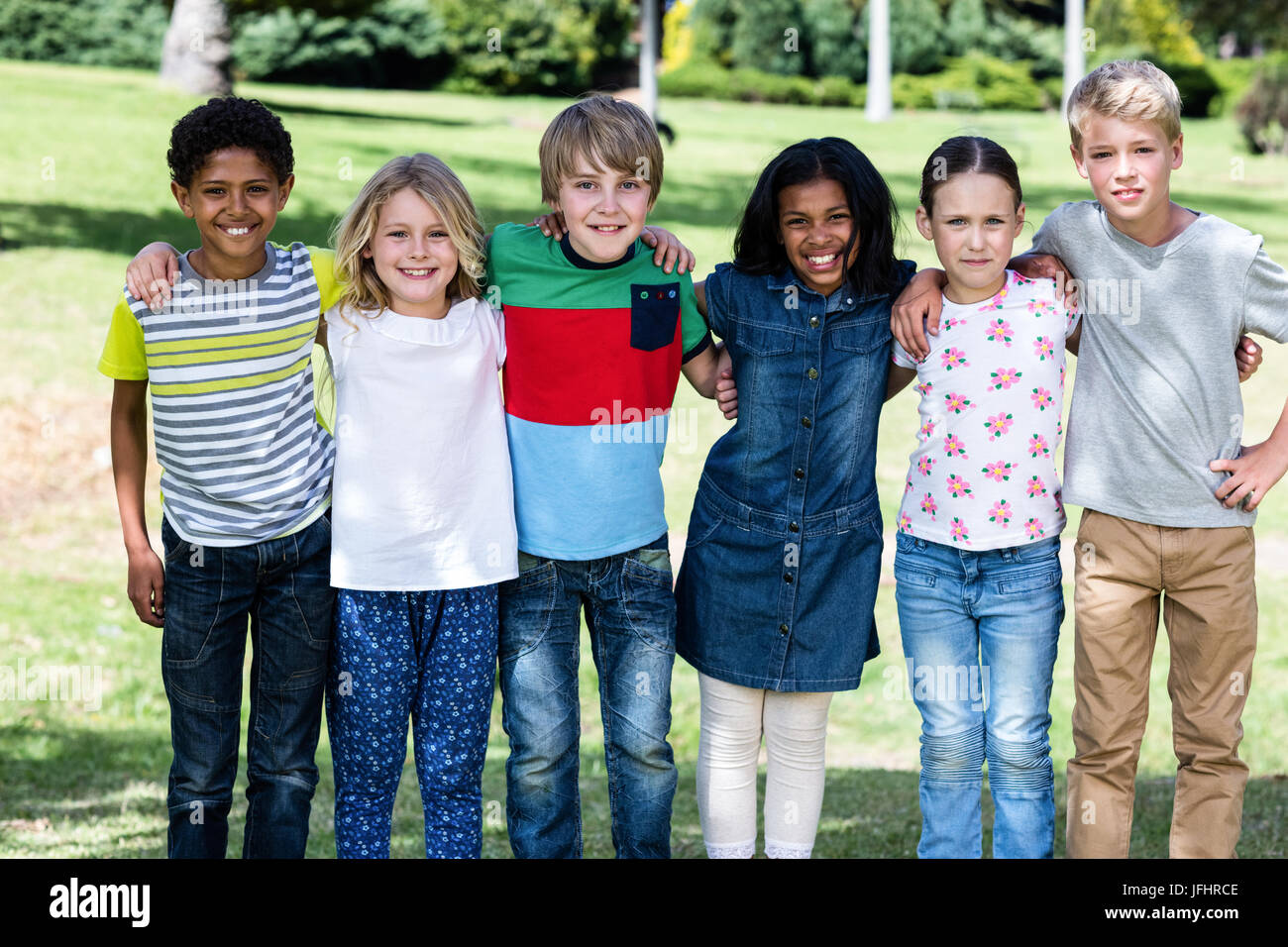 Portrait of happy children standing together in park Stock Photo - Alamy