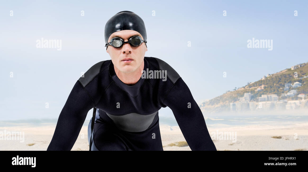 Composite image of confident swimmer in wetsuit Stock Photo - Alamy