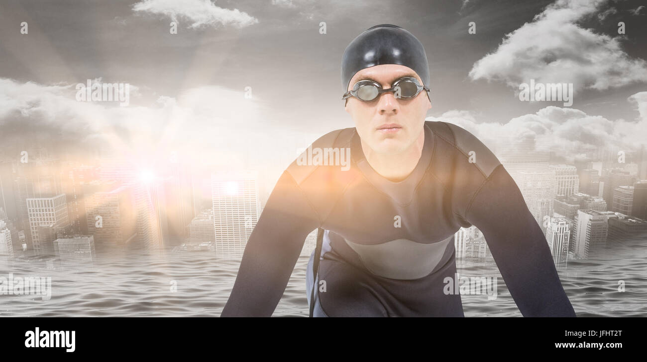 Composite image of confident swimmer in wetsuit Stock Photo - Alamy