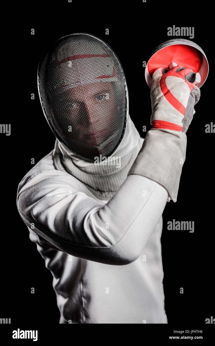 Close-up of man wearing fencing suit practicing with sword Stock Photo ...