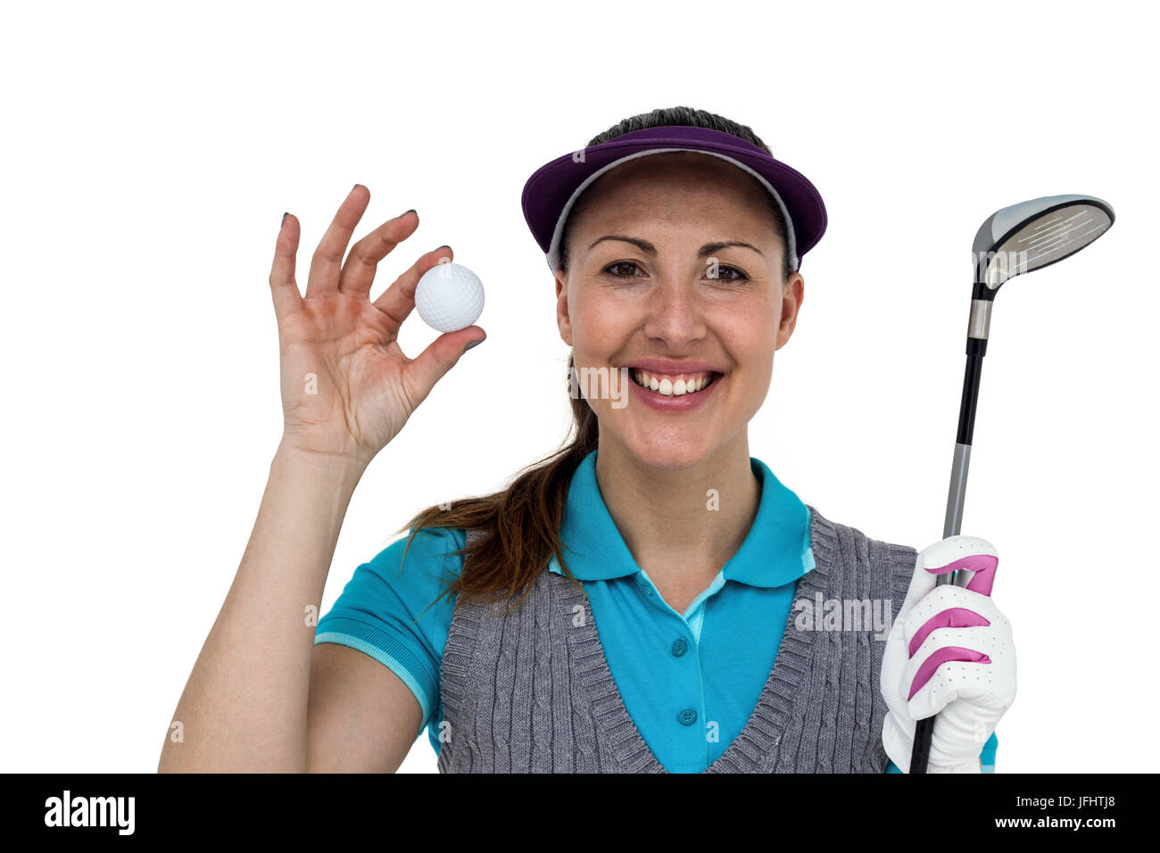 Golf player posing with a golf club and golf ball Stock Photo - Alamy