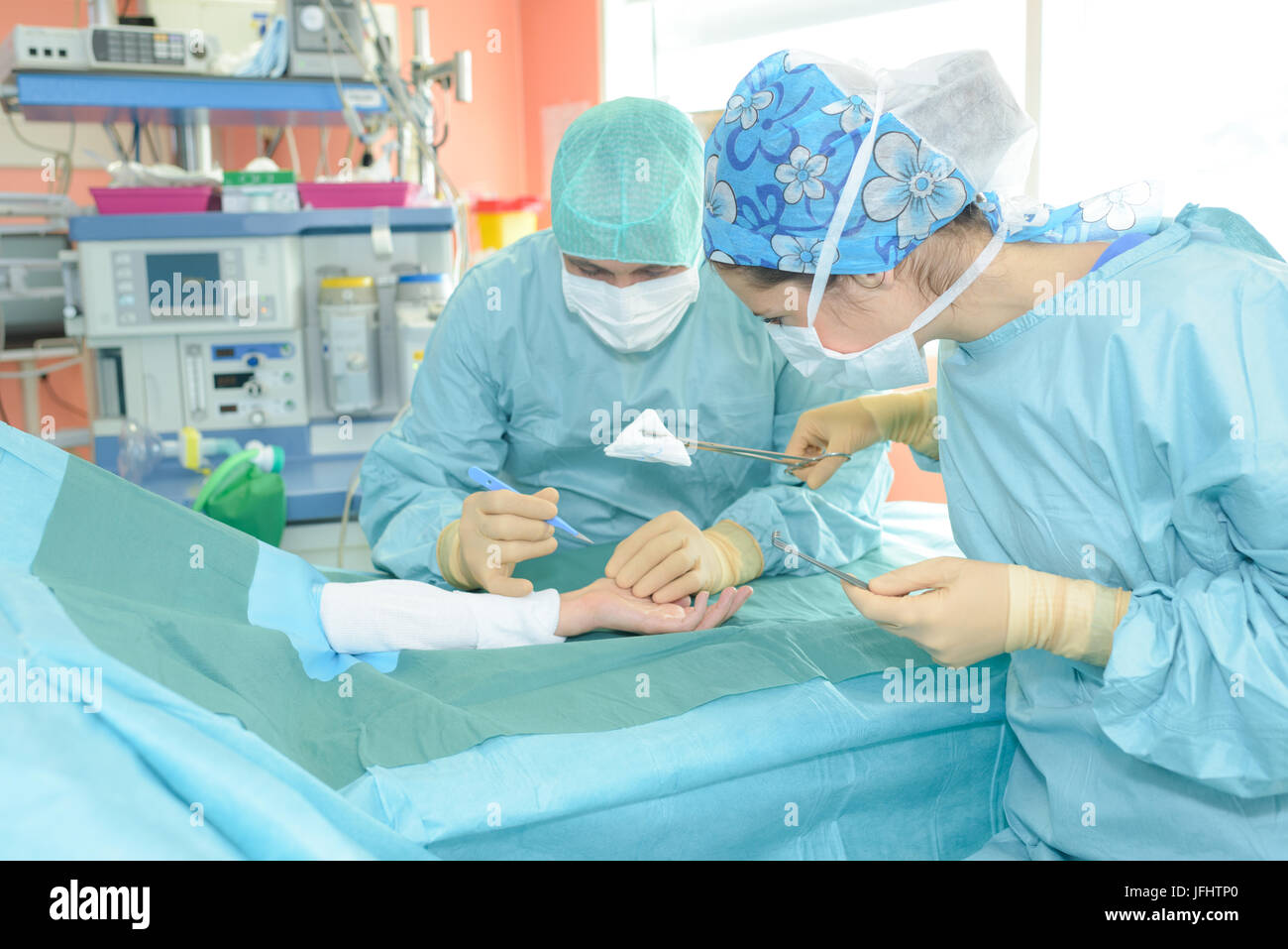 Surgeon performing operation on patient's hand Stock Photo - Alamy