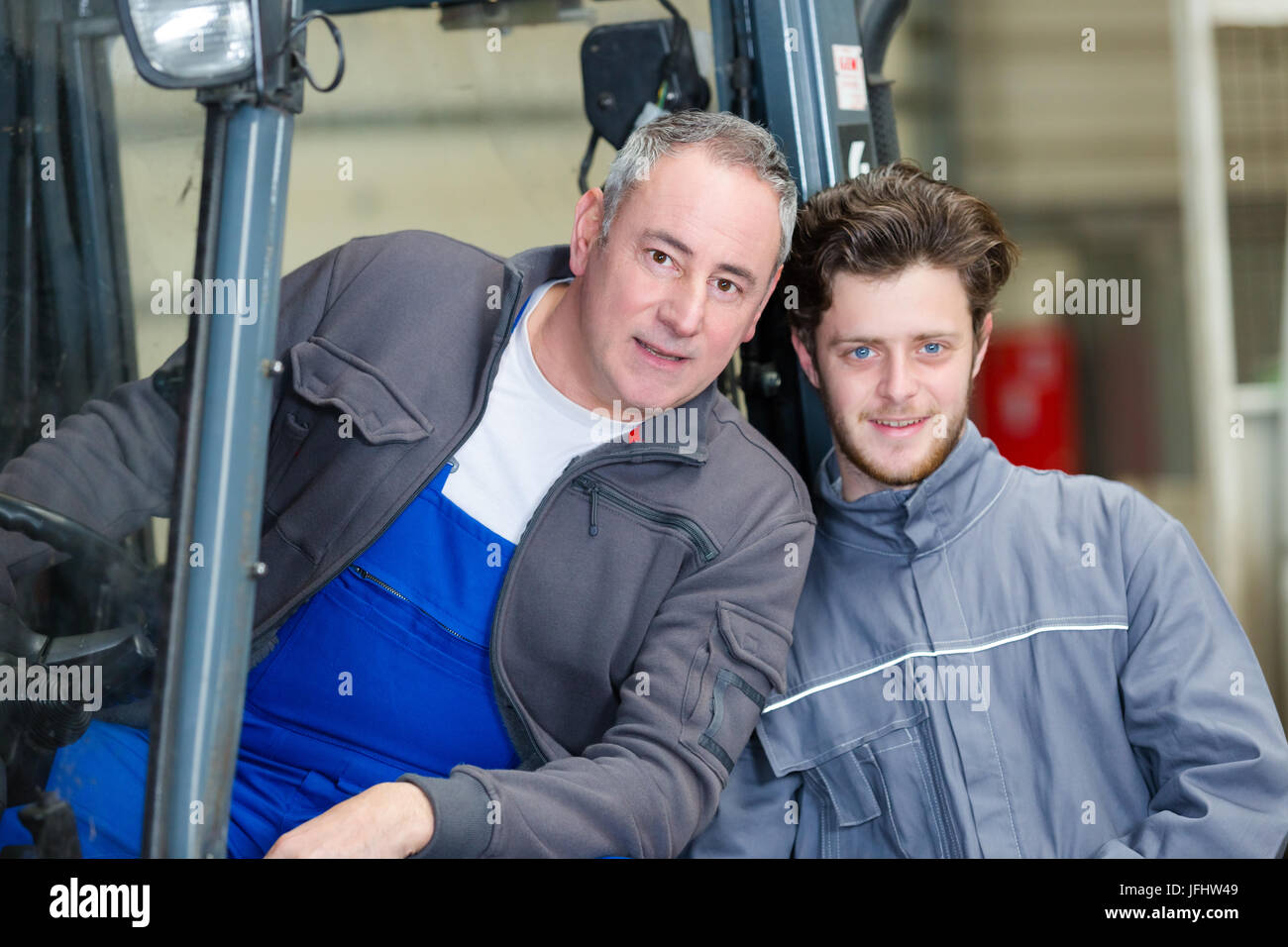 portrait of two men by forklift Stock Photo - Alamy