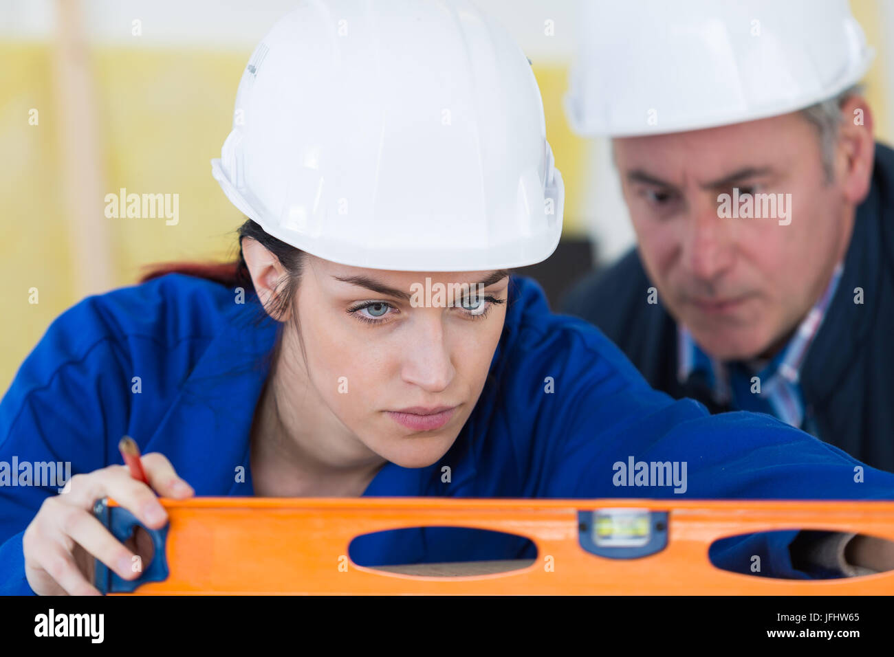 Female worker using spirit level Stock Photo - Alamy