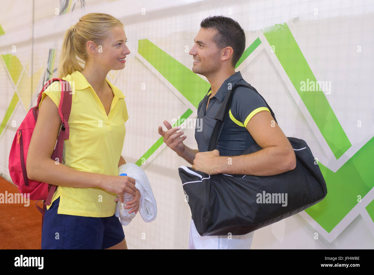 Male and female athletes in discussion Stock Photo - Alamy