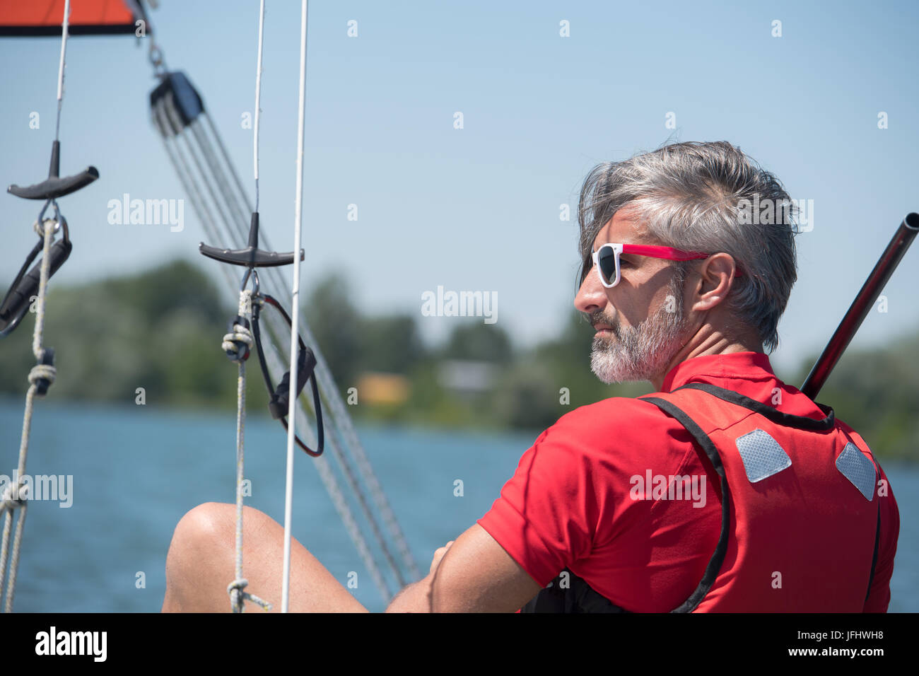 Mature man on sailing vessel Stock Photo - Alamy