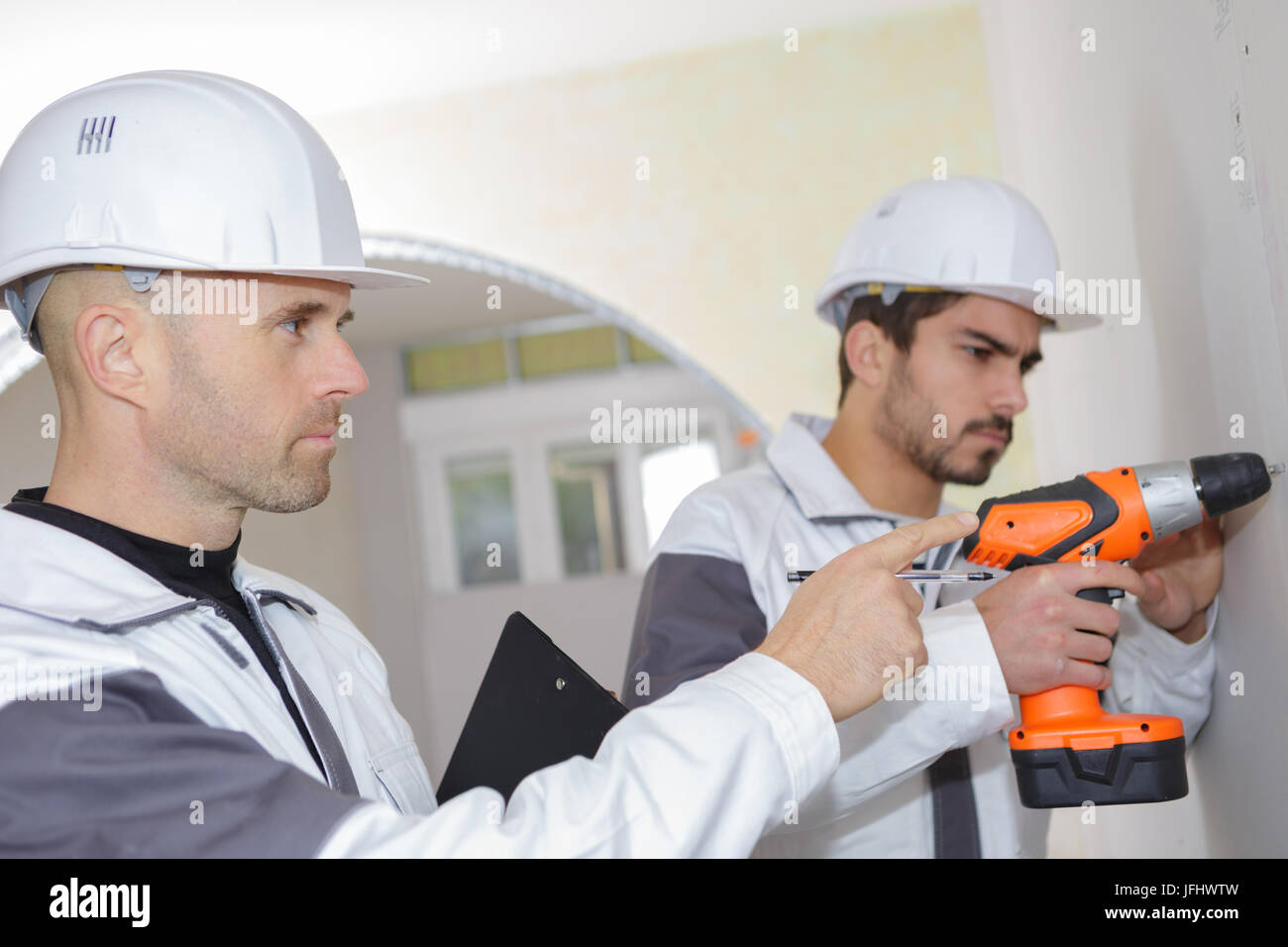 worker with drill perforator making hole at construction site Stock ...