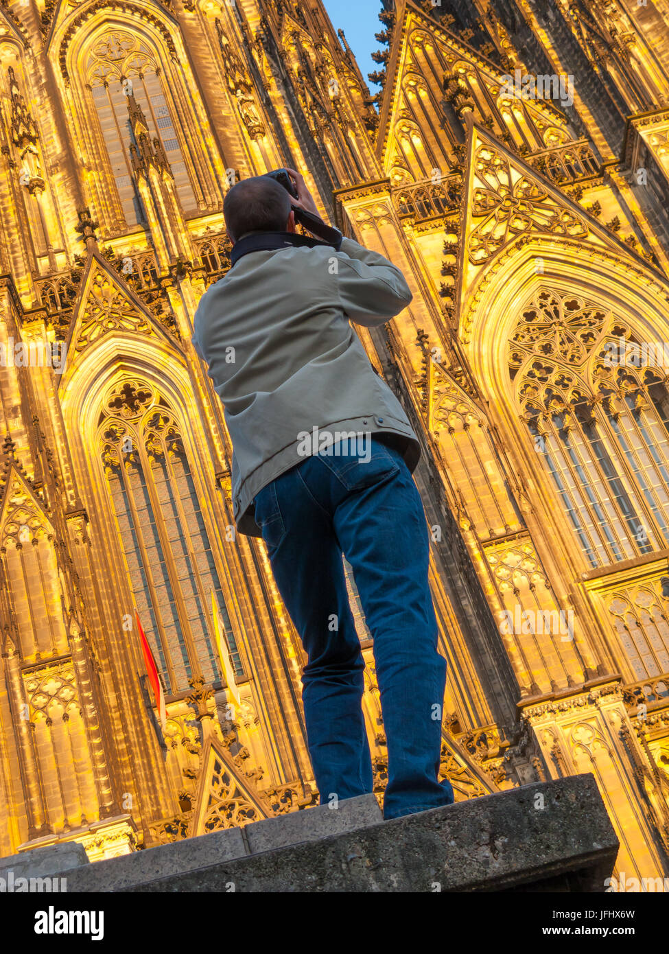 A photographer shoots the spires at the Dome at Cologne, Koln Dom ...