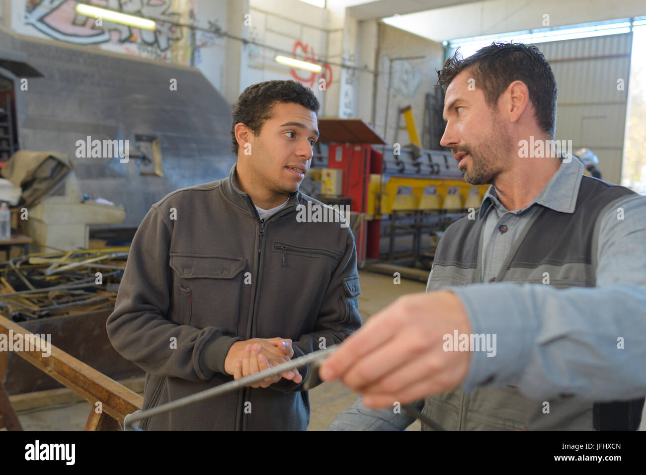 factory workers having discussion in factory Stock Photo - Alamy