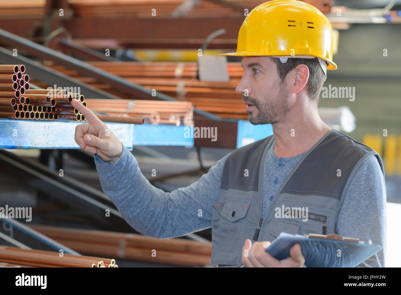 factory worker choosing welding fitting for industrial plumbing Stock ...