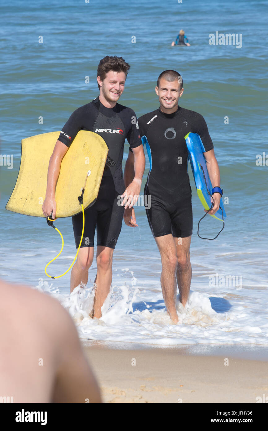 two boys bodyboarding Stock Photo - Alamy