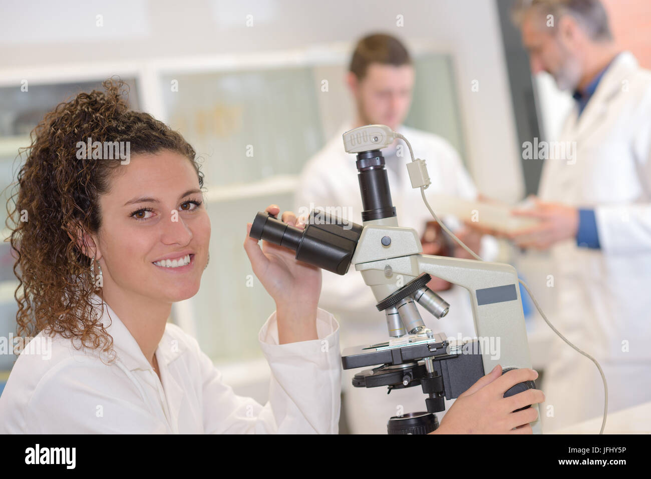 student posing holding a microscope Stock Photo - Alamy
