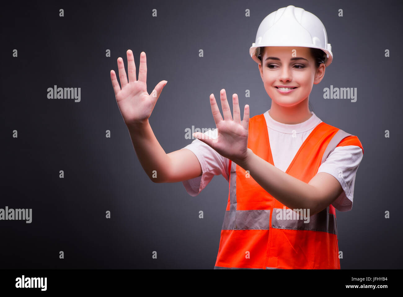Cute construction worker pressing virtual buttons Stock Photo - Alamy