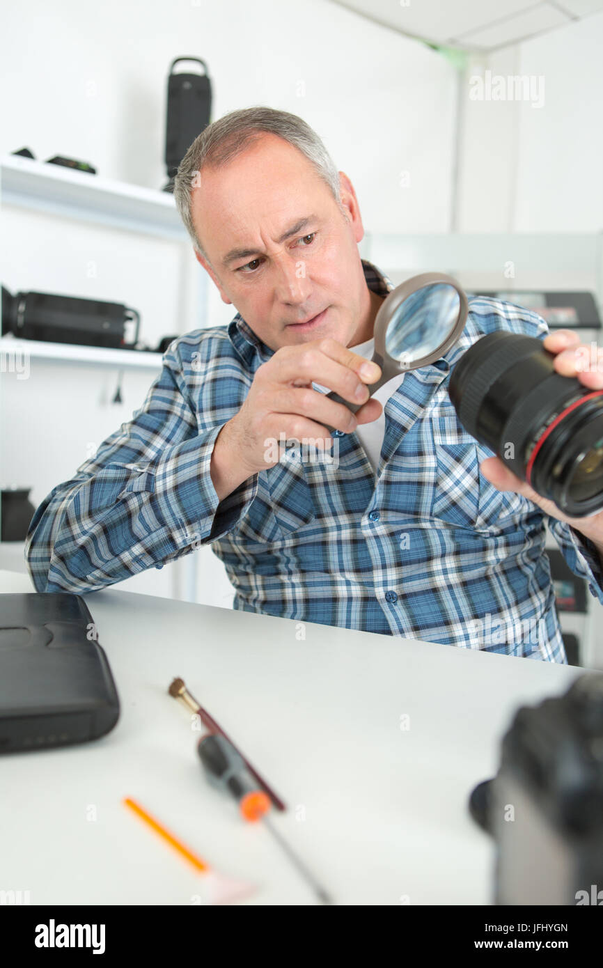man using a magnifier Stock Photo - Alamy