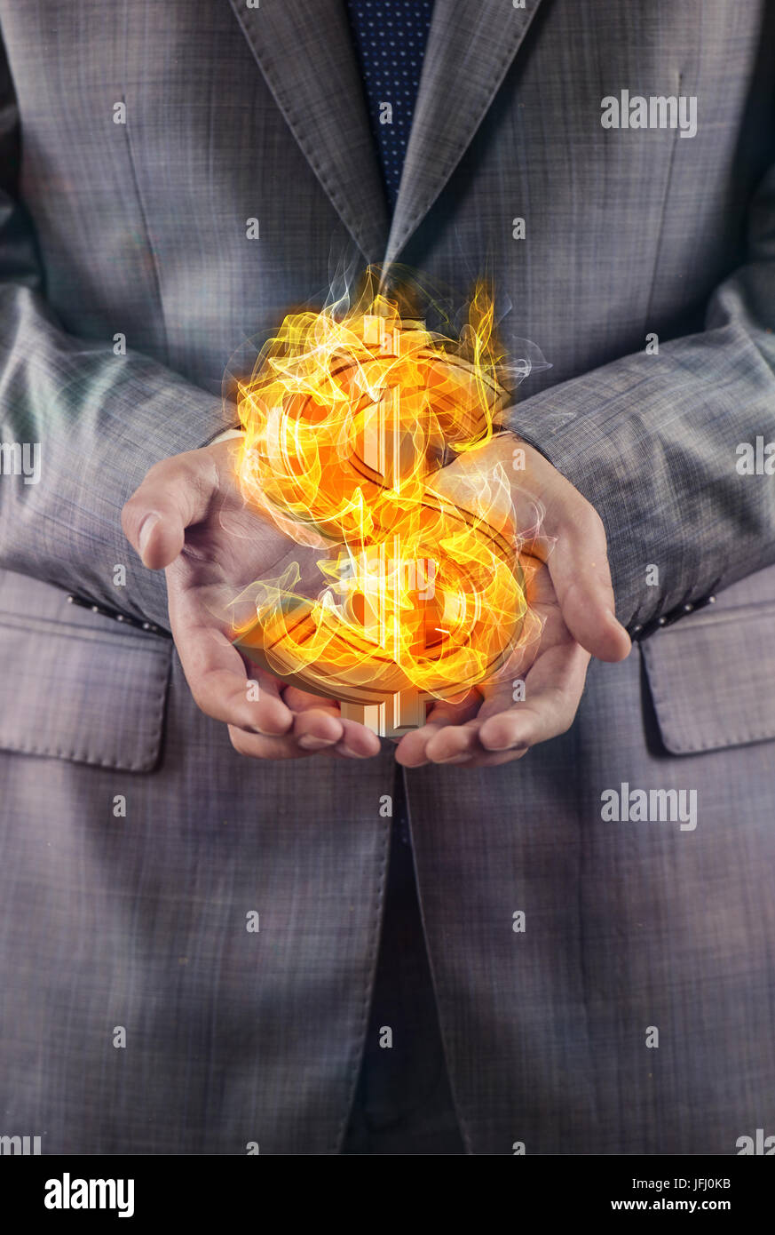 Businessman holding burning american dollar sign Stock Photo - Alamy
