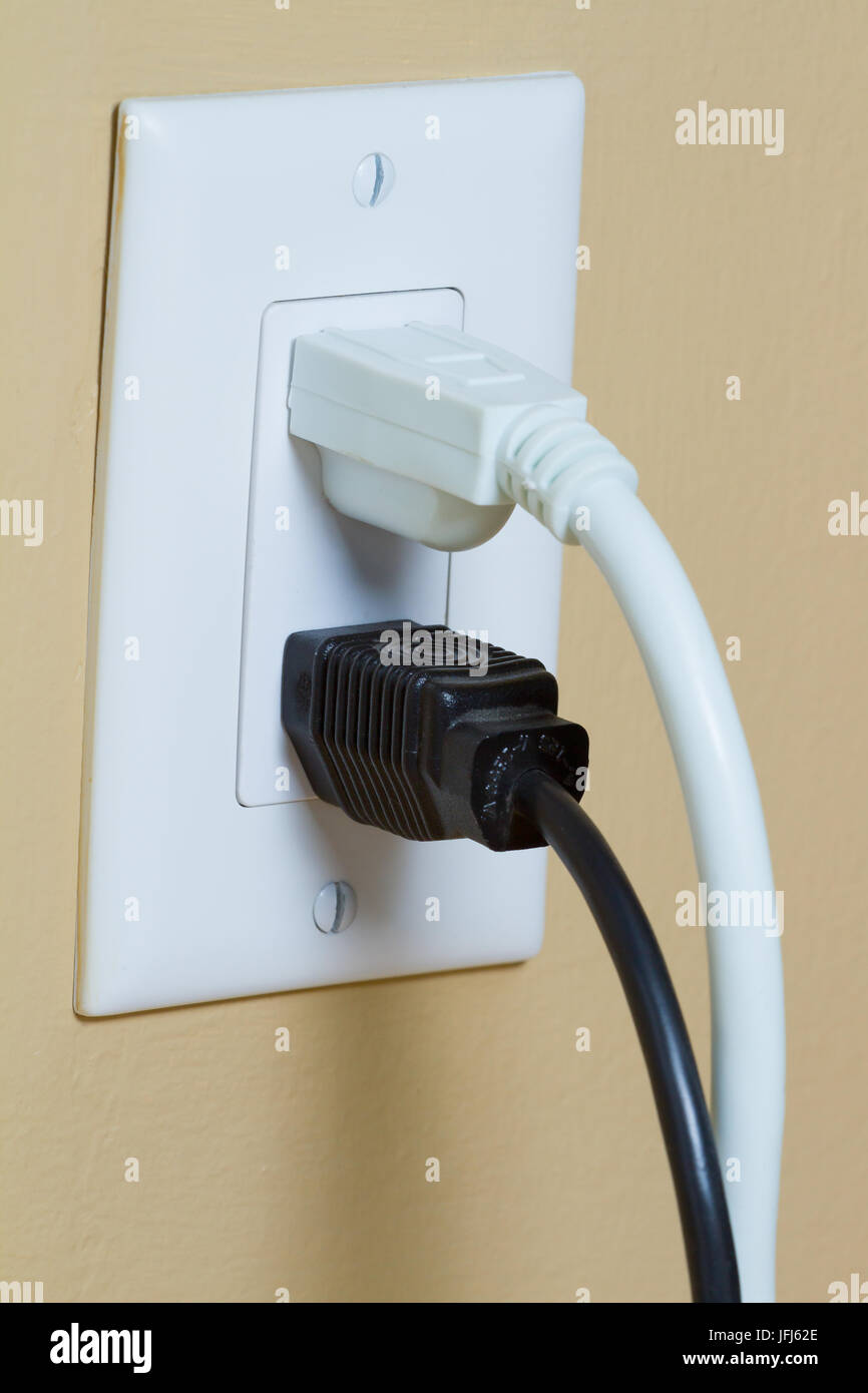 Two Electric black and white cable in Electrical Outlet on the Wall ...