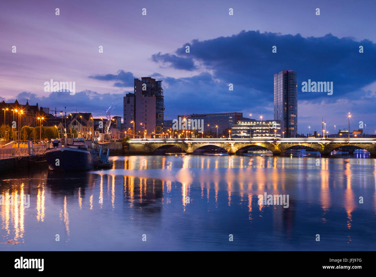 UK, Northern Ireland, Belfast, city skyline along River Lagan, dusk ...