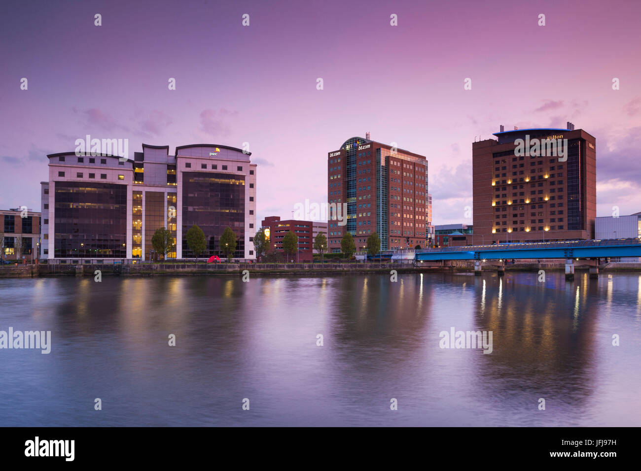 UK, Northern Ireland, Belfast, city skyline along River Lagan, dusk ...
