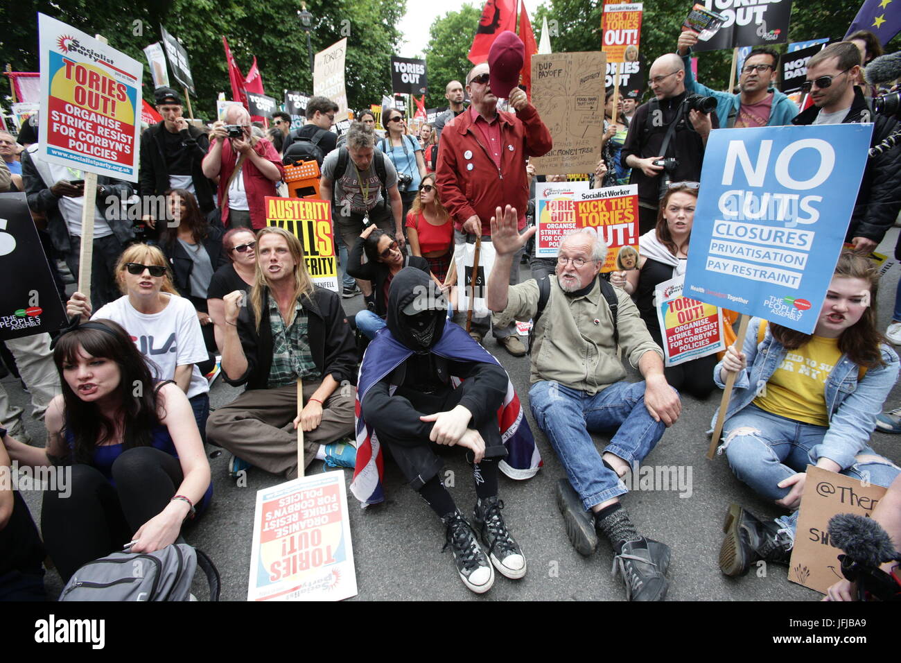 A group of people take part in a sit down protest outside Downing ...