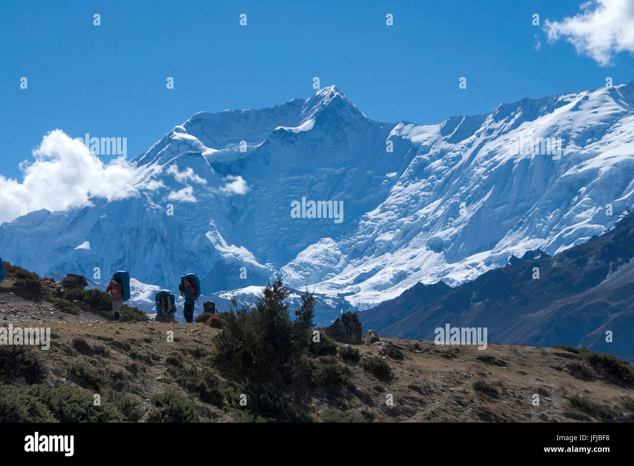 Porters on Annapurna Circuit, Annapurna II on background, Himalaya ...