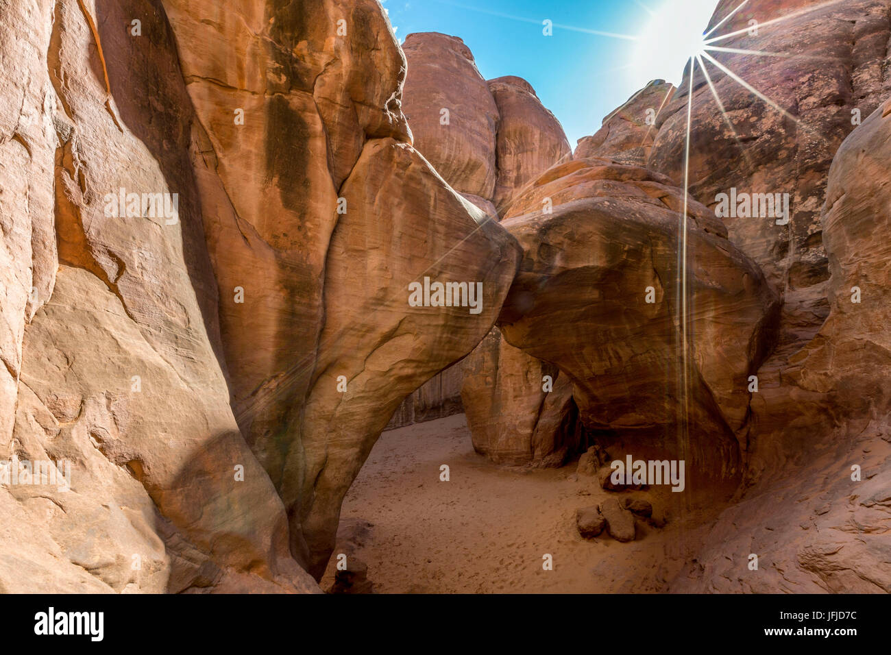 The sun shines over Sand Dune Arch, Arches National Park, Moab, Grand ...