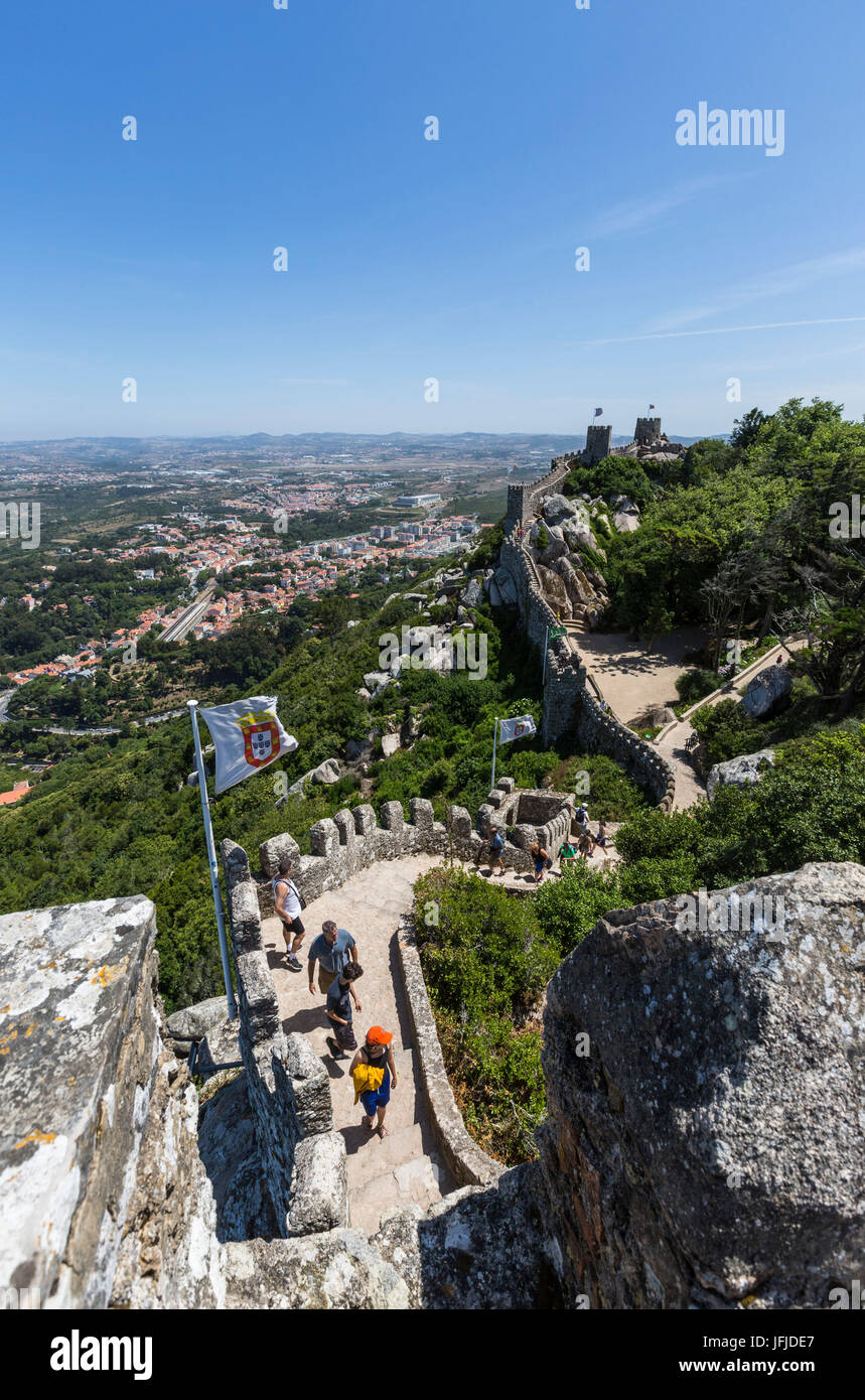 Tourists proceed on fortified stone path of the ancient Castelo dos ...