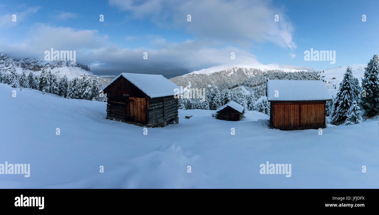 Two wooden lodges covered in snow, Passo delle Erbe, Bolzano, Trentino ...