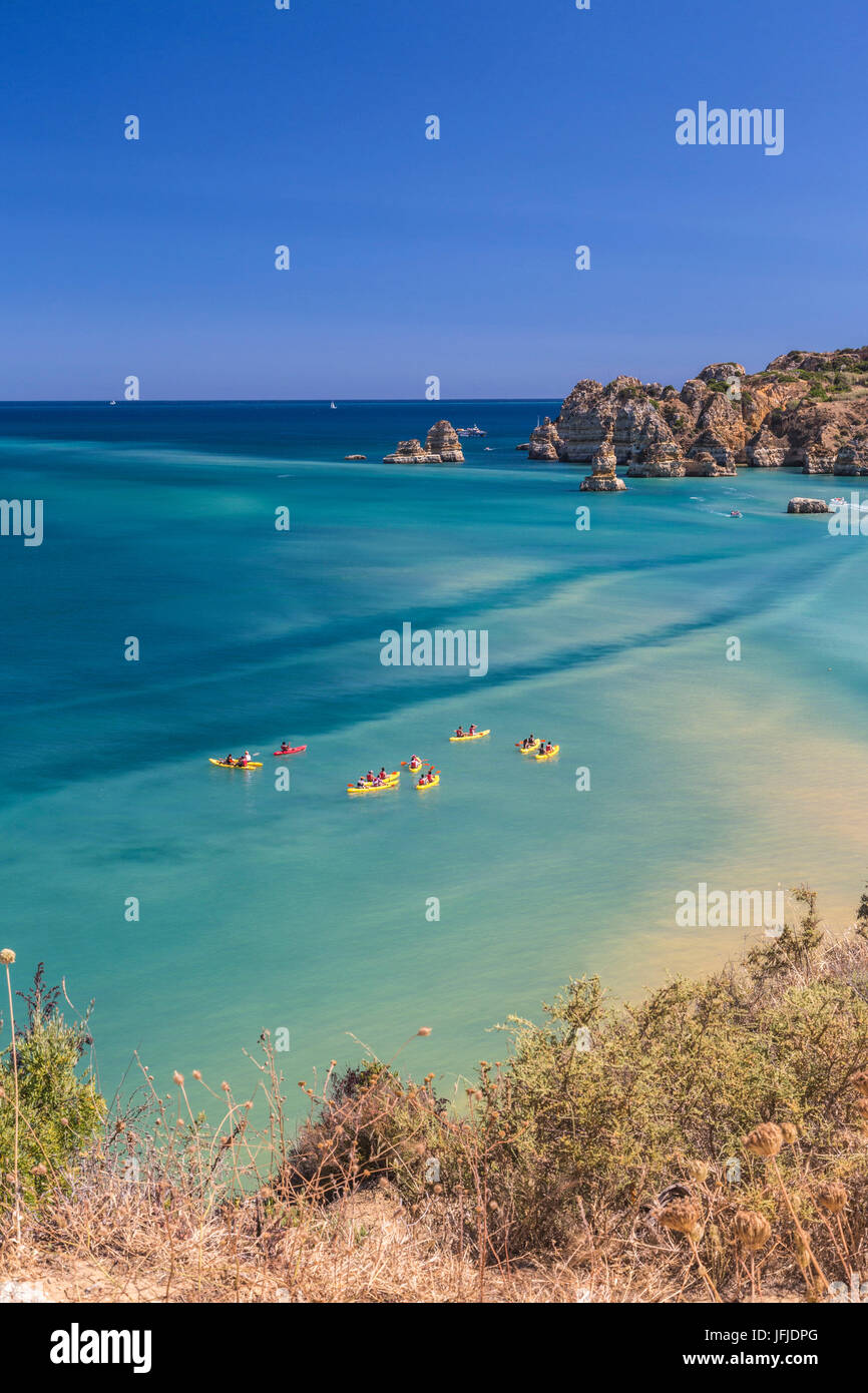 Canoes in the turquoise water of the Atlantic Ocean surrounding Praia ...