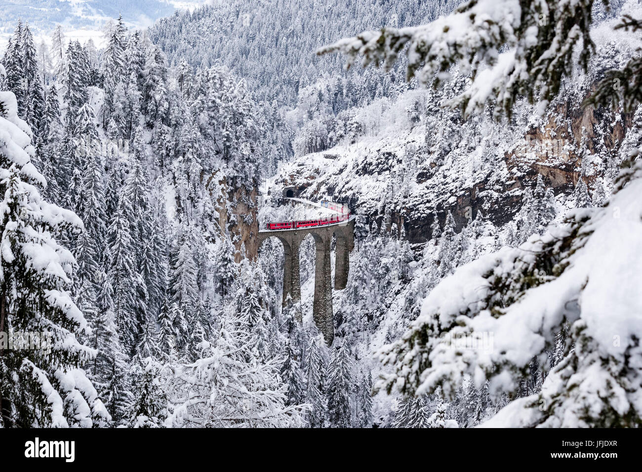 The Bernina Express red train as it passes over the Landwasser bridge ...