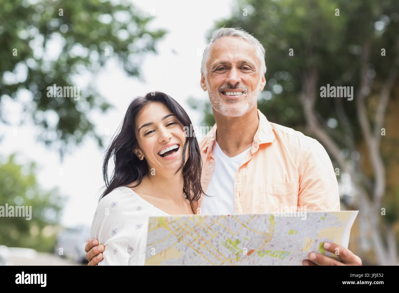 Couple holding map in city Stock Photo - Alamy