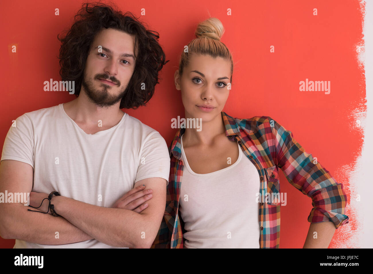 Portrait of a happy young smiling couple in love over color background ...