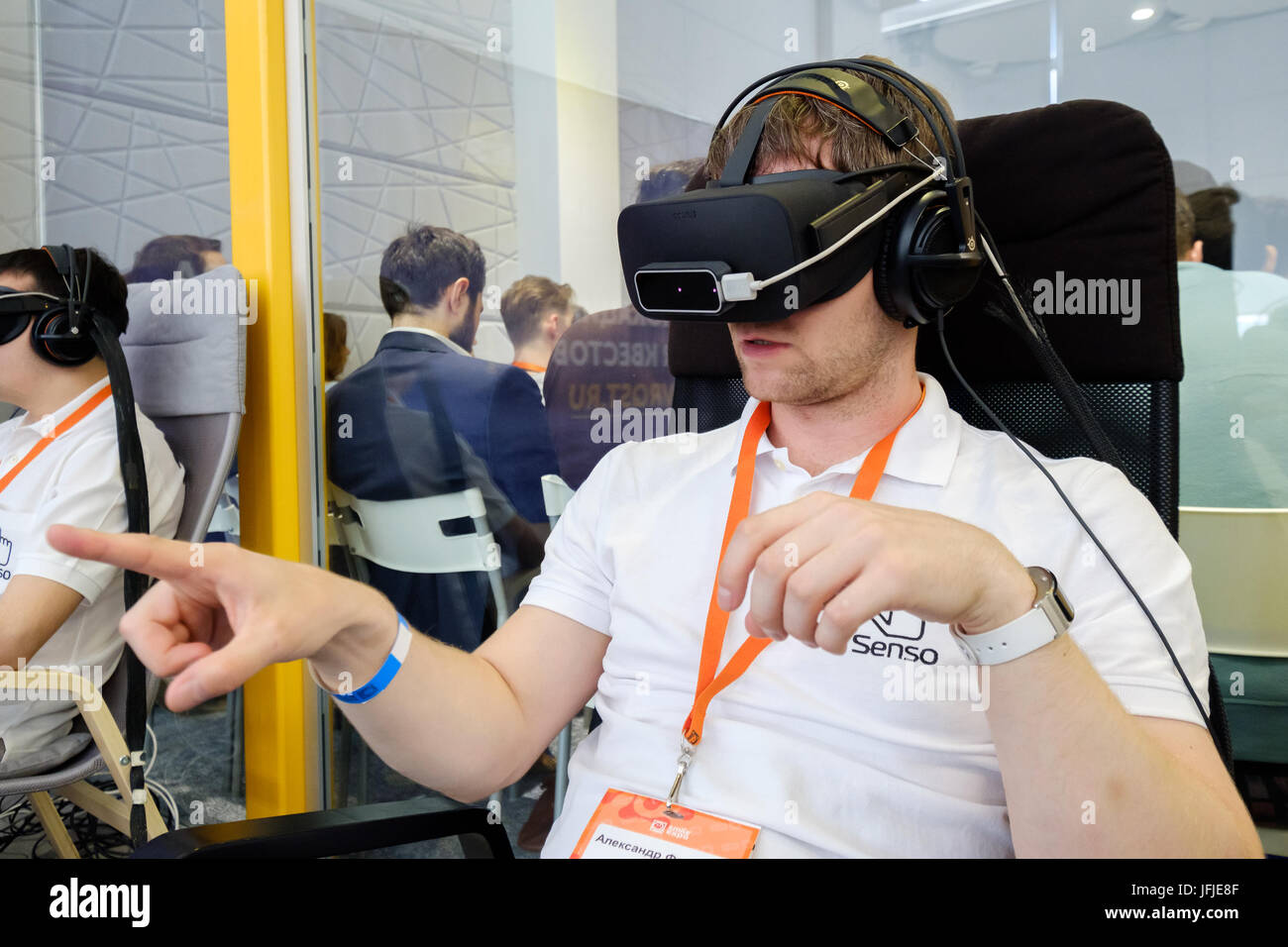 VR conference visitor tests virtual reality helmet Stock Photo - Alamy