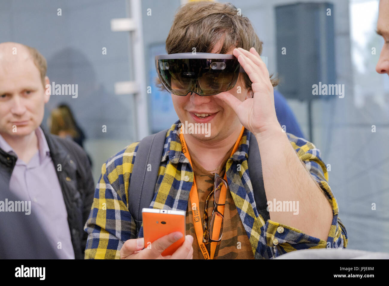 Young man testing hololens VR glasses at VR conference Stock Photo - Alamy