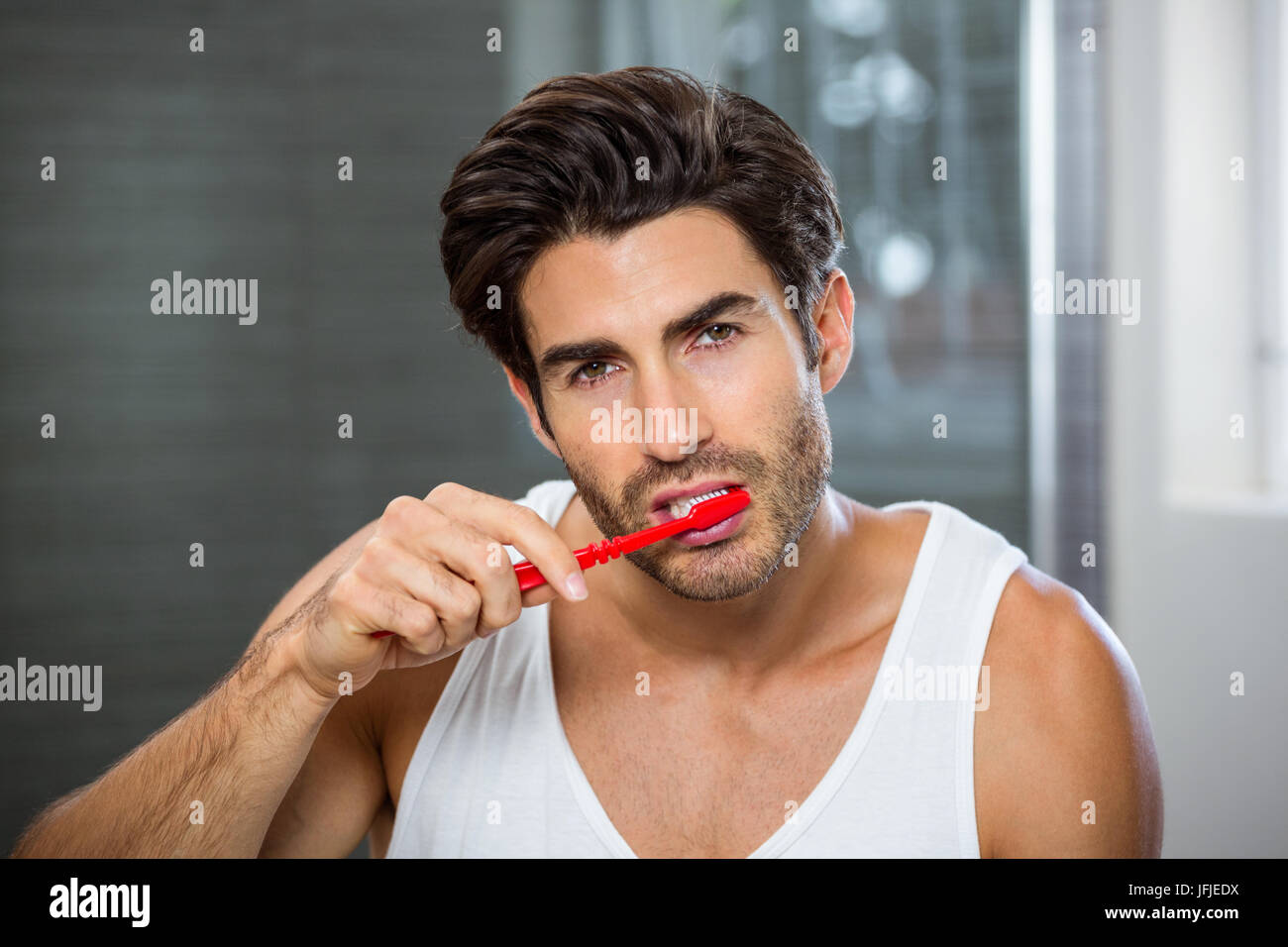Young man brushing teeth Stock Photo - Alamy