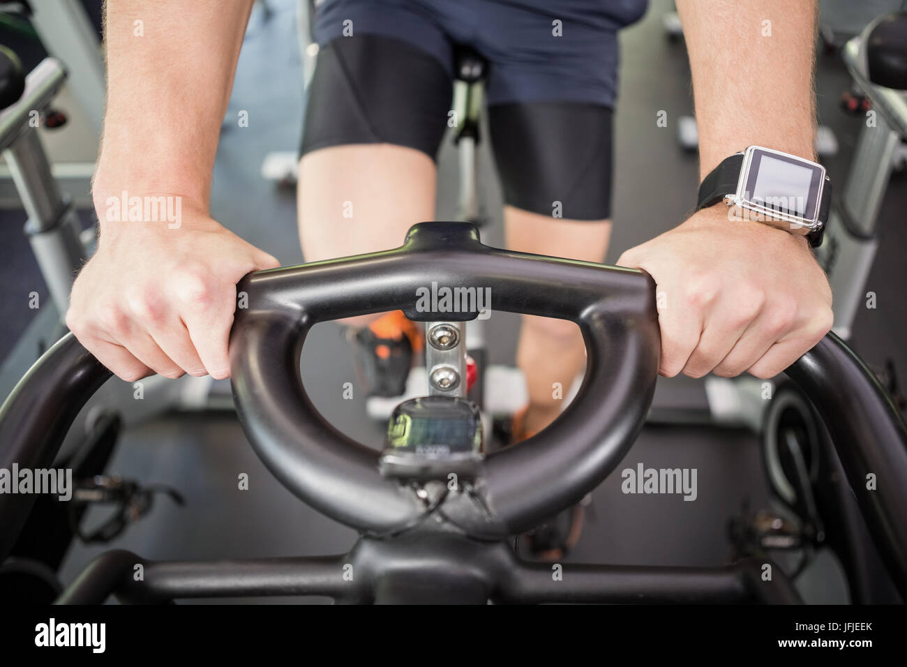 Man working out on exercise bike at spinning class Stock Photo - Alamy