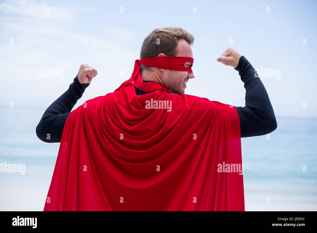 Man in superhero costume standing at sea shore Stock Photo - Alamy
