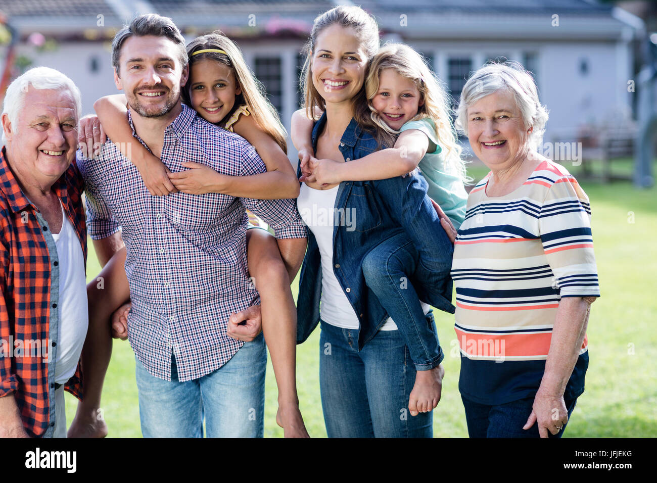Portrait of multi-generation family standing in garden Stock Photo - Alamy