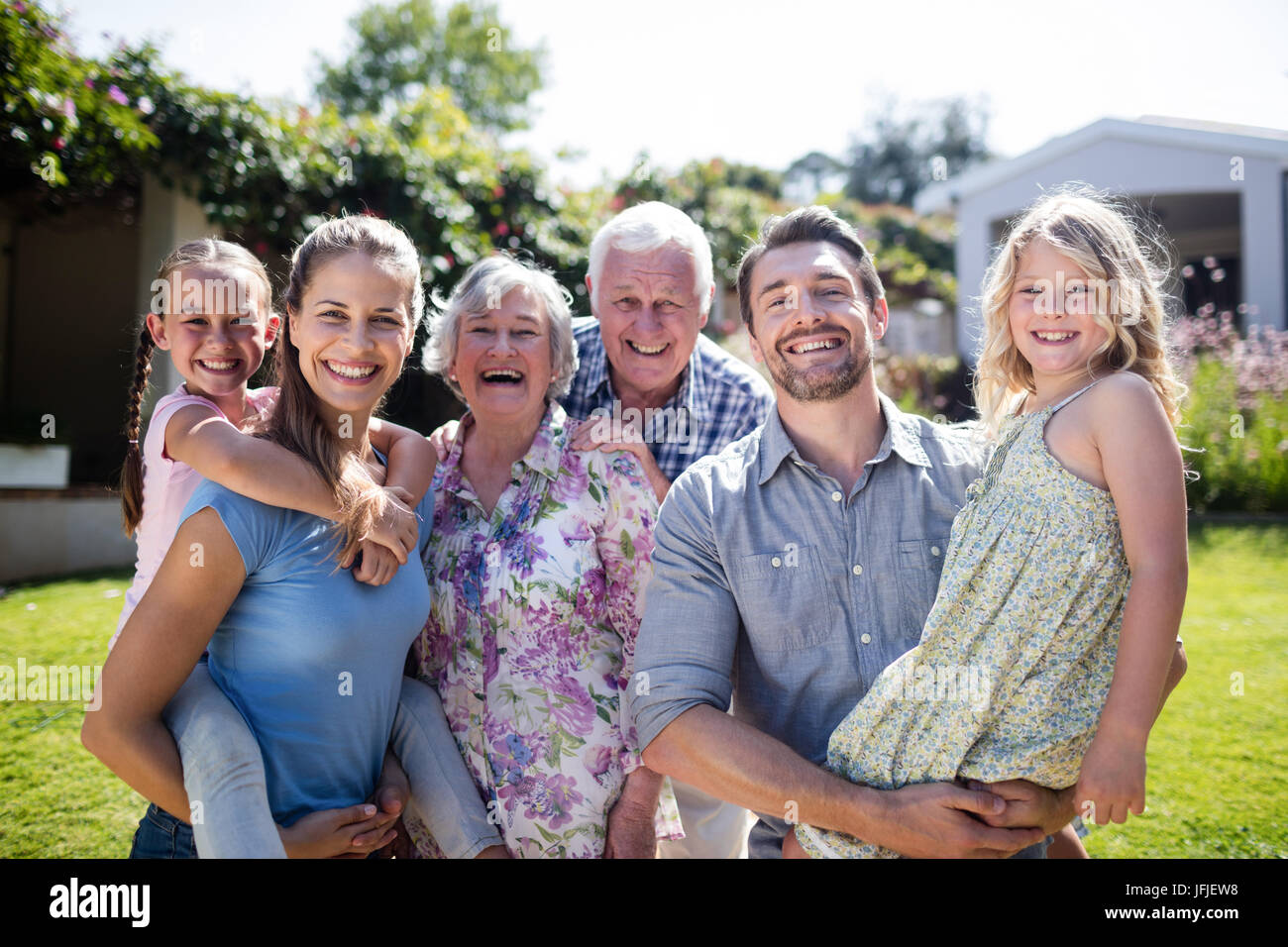 Portrait of a multi-generation family in the garden Stock Photo - Alamy