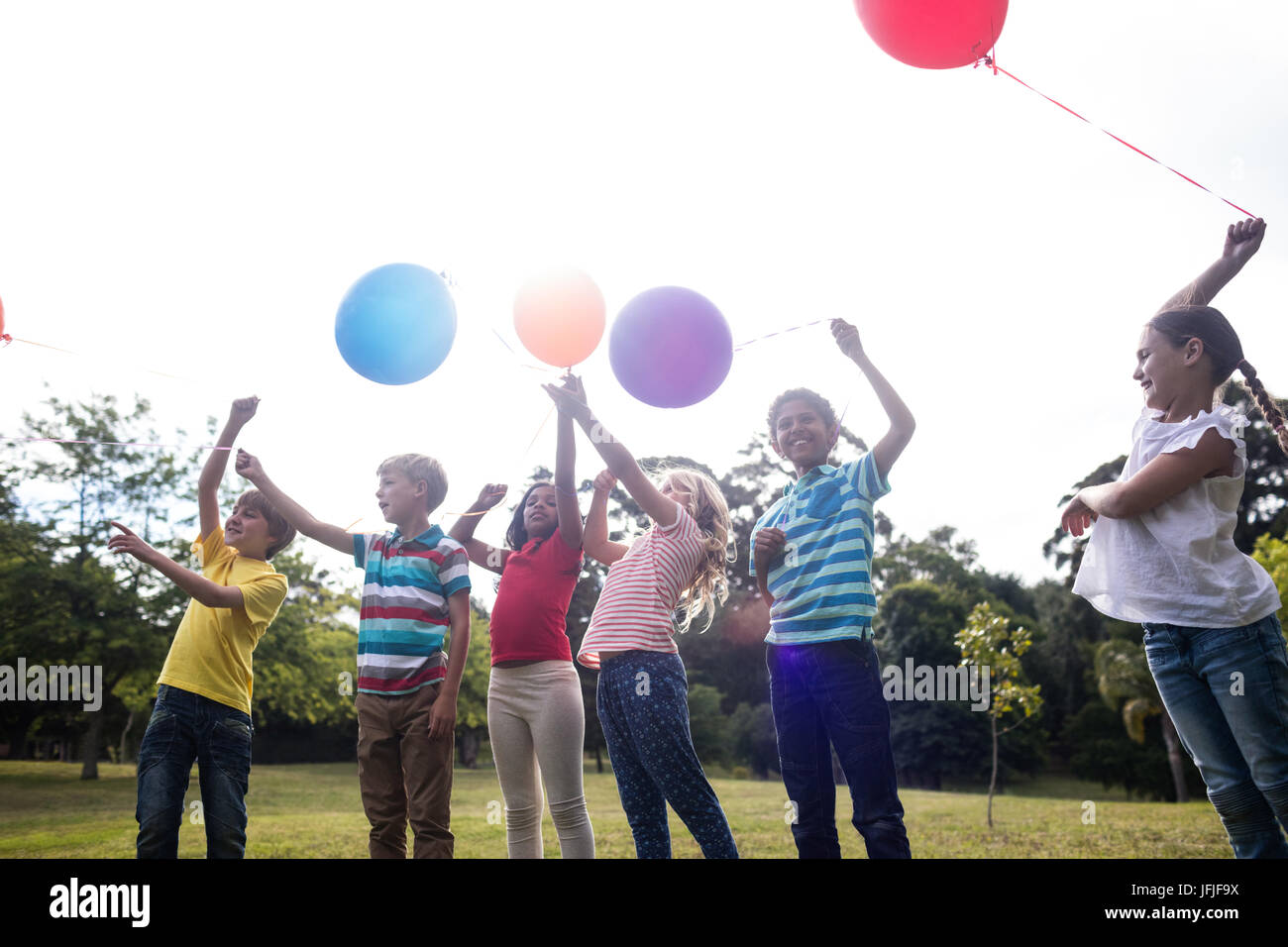 Happy children playing with balloons in the park Stock Photo - Alamy
