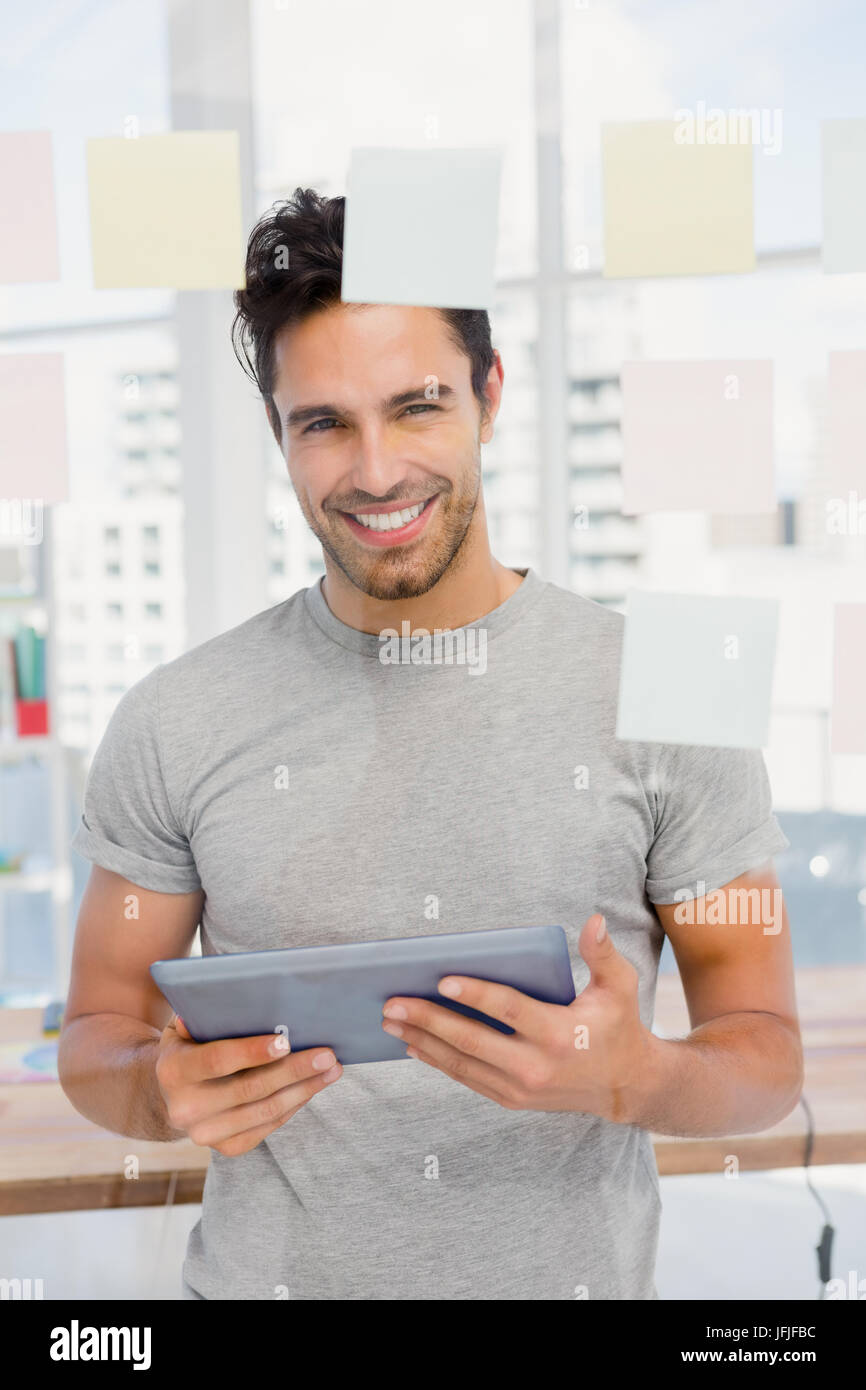 Portrait of man holding digital tablet and sticky notes Stock Photo - Alamy