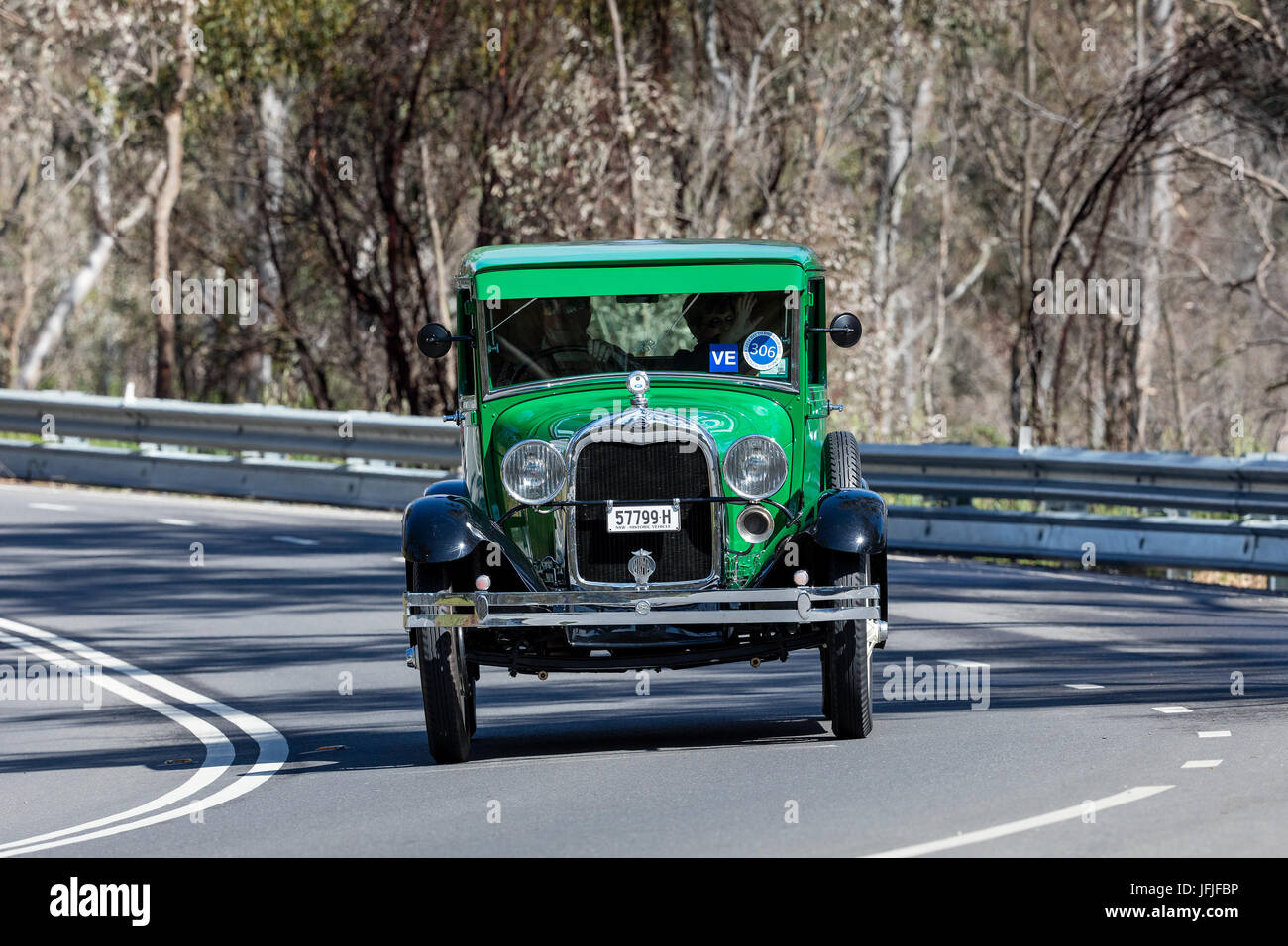 Vintage 1928 Ford Model A driving on country roads near the town of ...