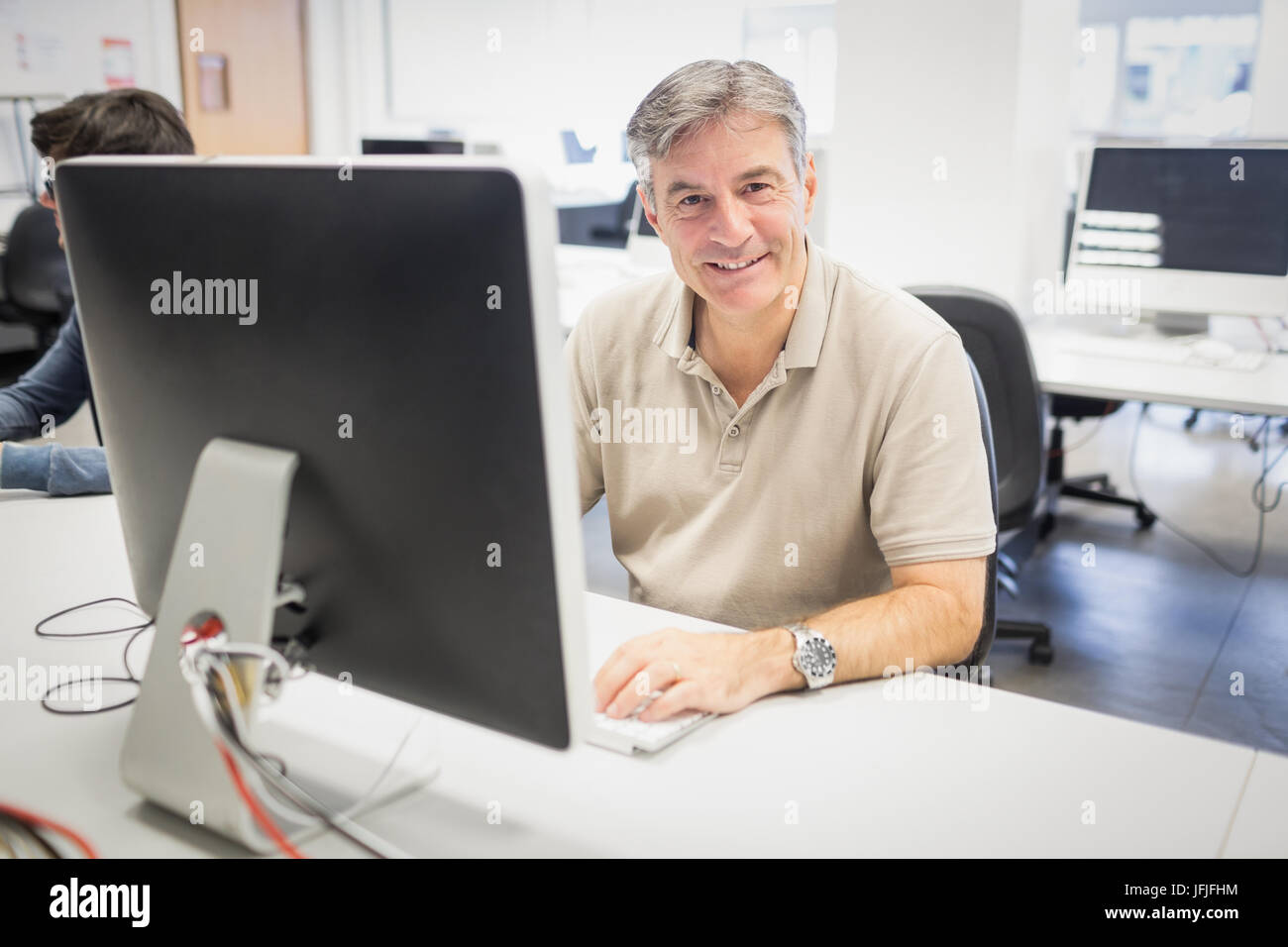 Portrait of happy professor working on computer Stock Photo - Alamy
