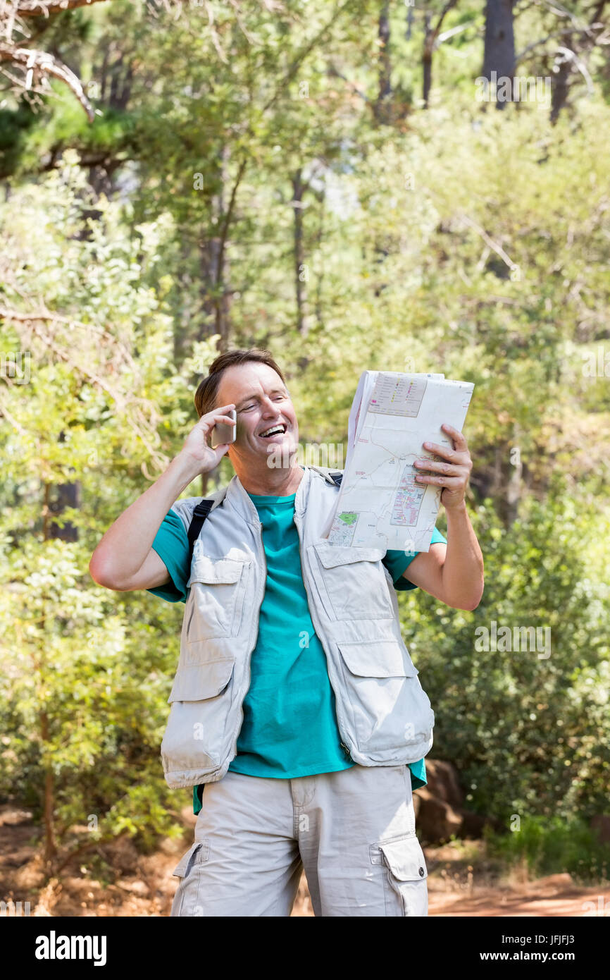senior man is reading and talking on the phone Stock Photo - Alamy