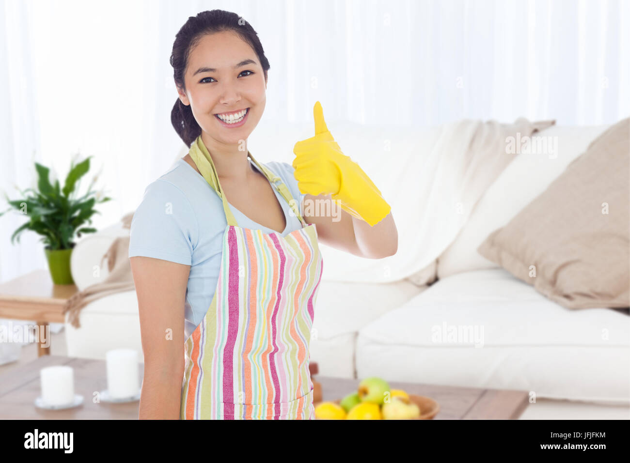 Composite image of woman in cleaning clothes giving thumbs up Stock ...