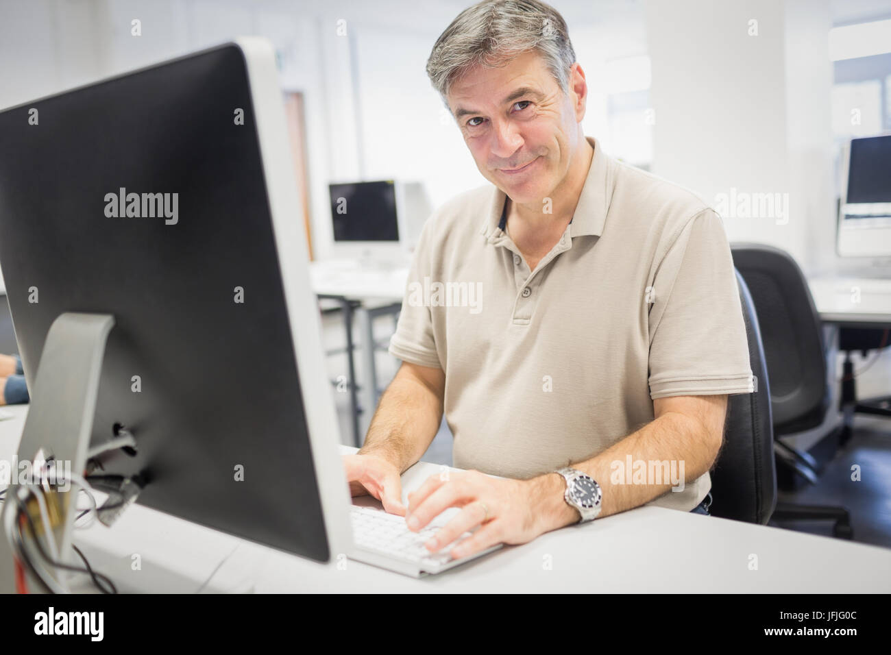 Portrait of happy professor working on computer Stock Photo - Alamy