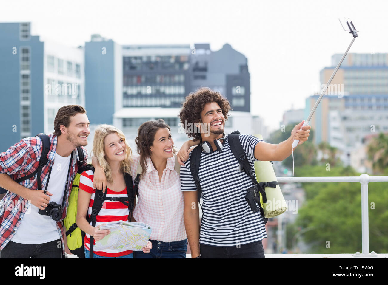 Group of friends taking selfie with selfie stick Stock Photo - Alamy
