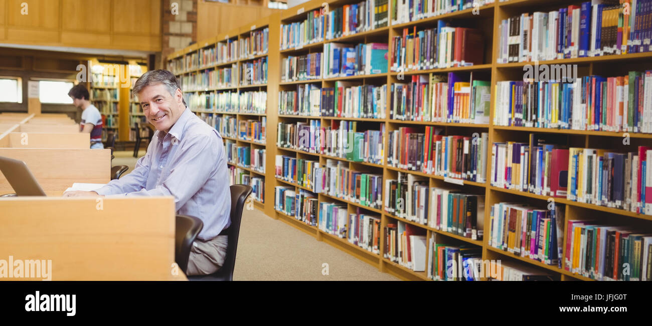 Portrait happy professor sitting desk hi-res stock photography and ...