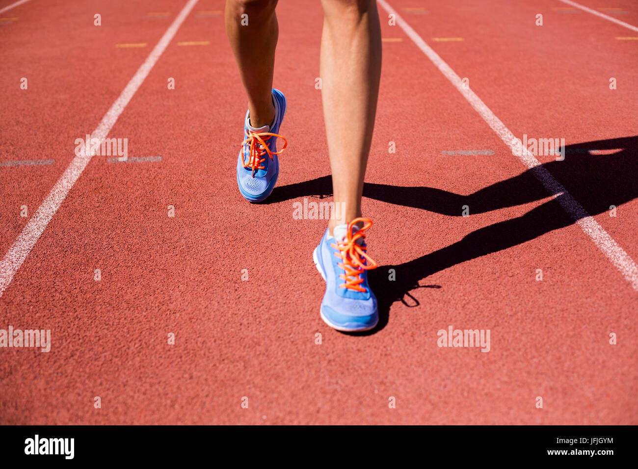 Female athlete feet running on the running track Stock Photo - Alamy